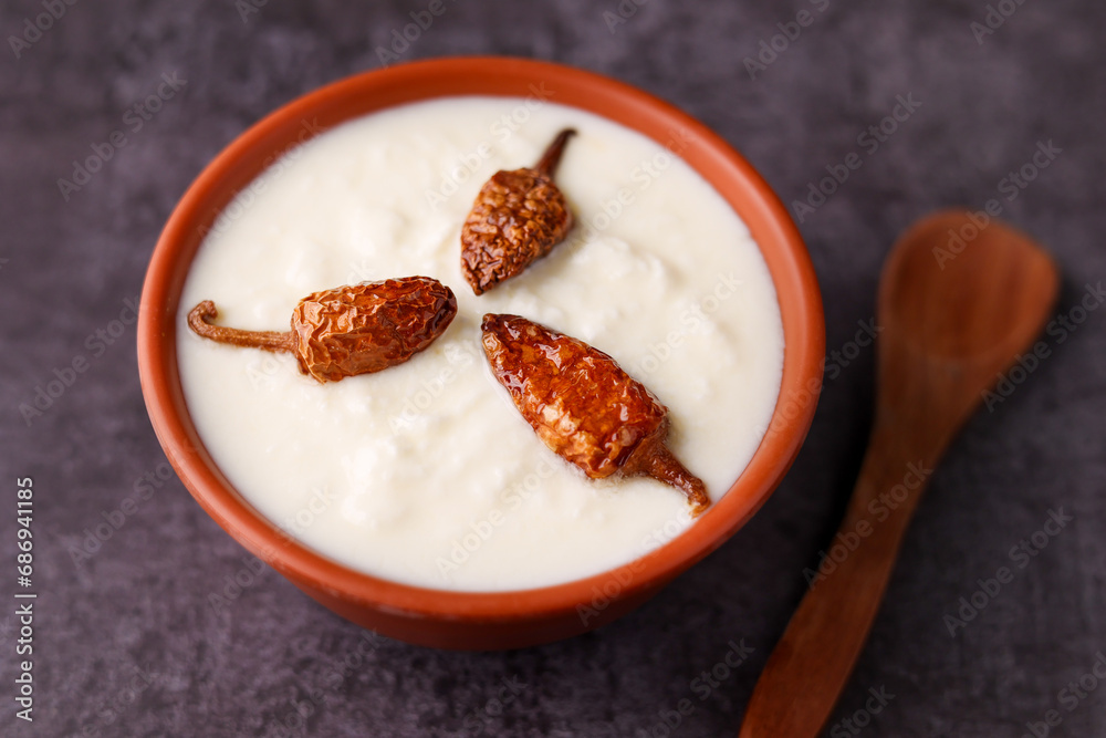 Bowl of homemade sour cream curd yogurt Dahi fresh herbs curry leaf ...