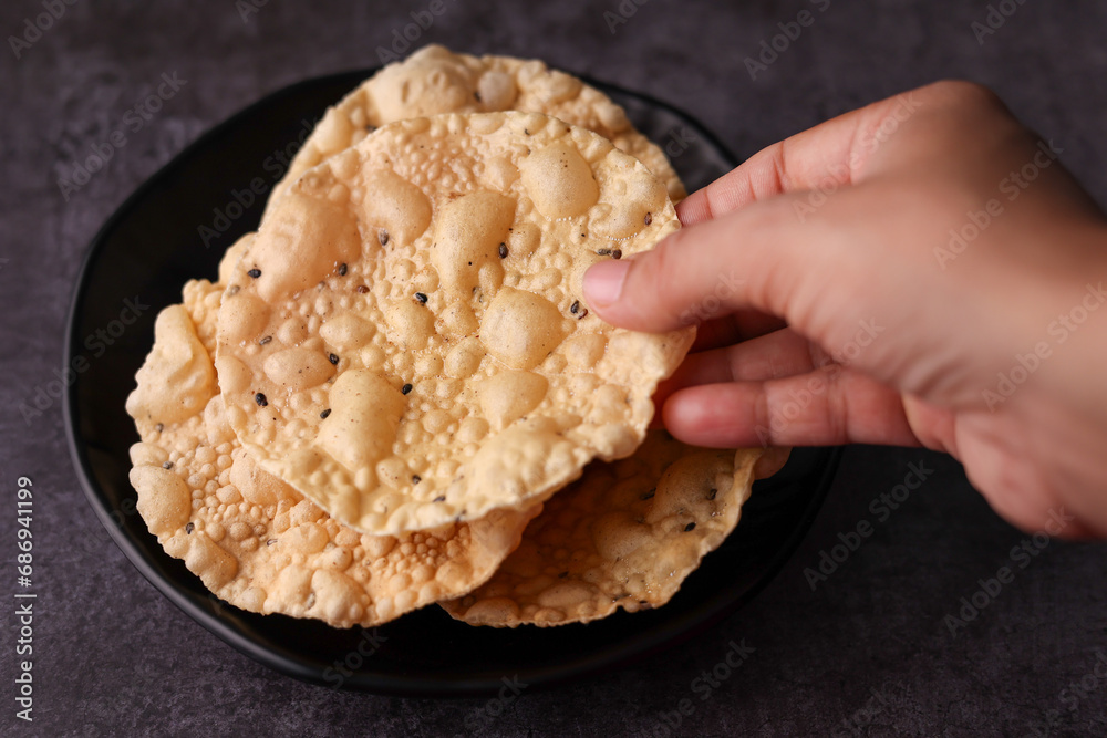 Papadam a traditional indian snack. papad or papadum in raw dried form ...