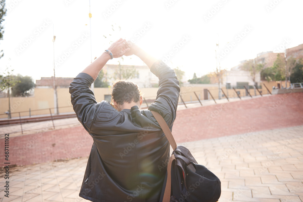 Man on his back walking and raising his arms for happiness Stock Photo ...