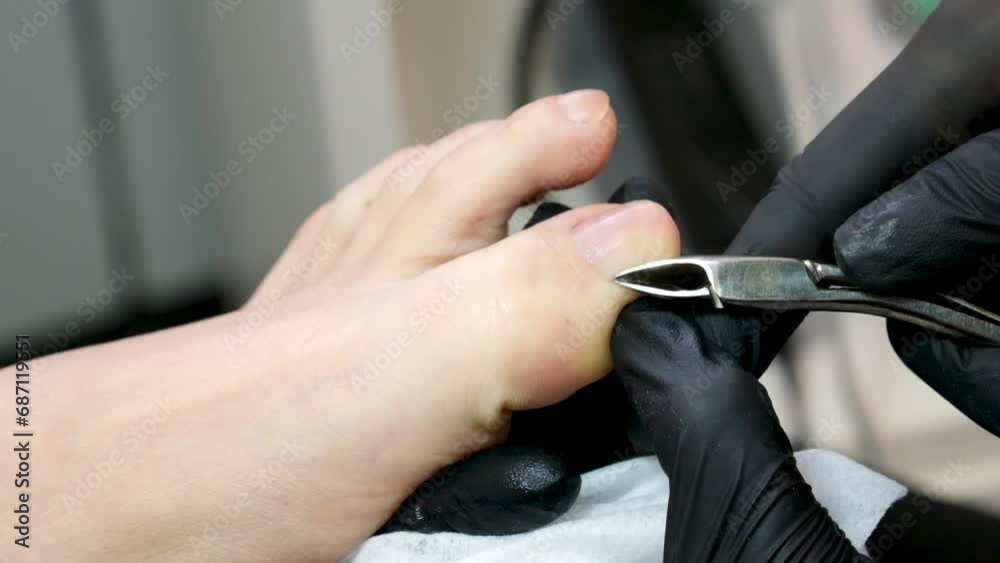Video Stock Close up of manicurist hand cutting dry skin on womans toes ...