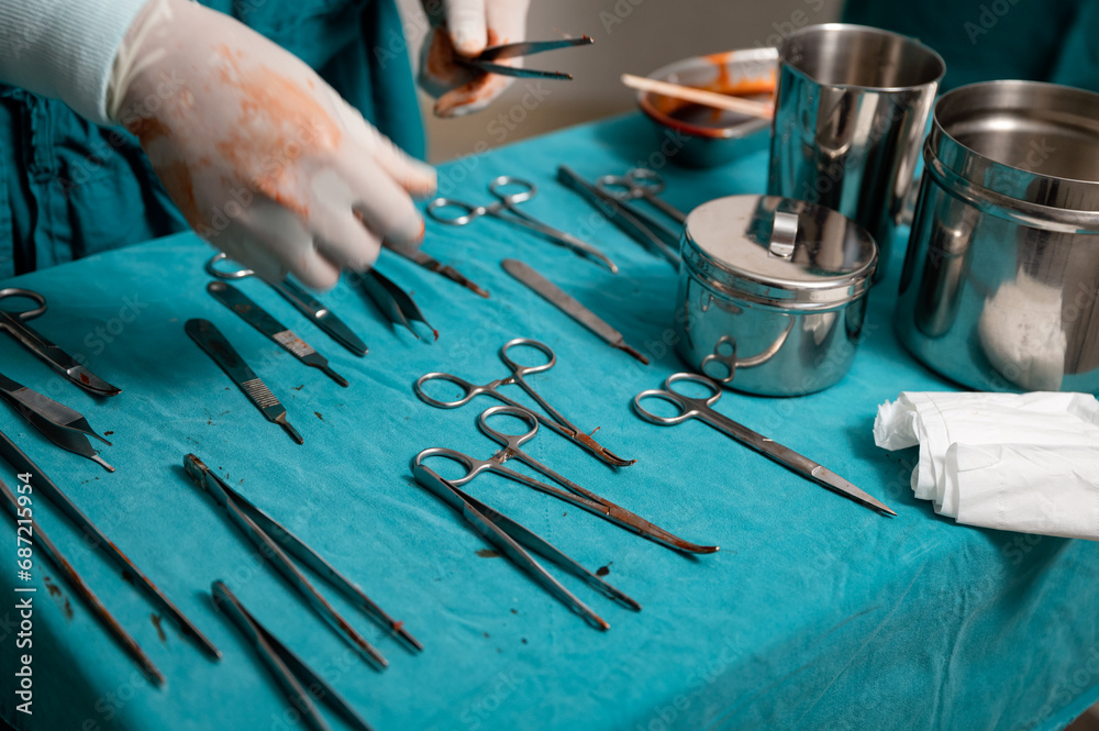 Surgeon hand wear medical gloves choosing surgical instruments on a ...