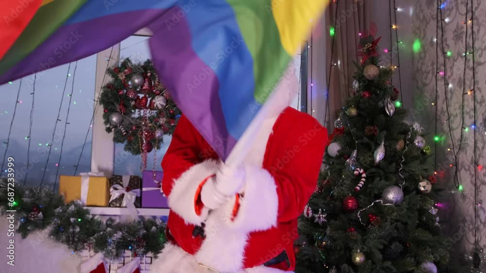 Close-up of Santa Claus waving rainbow LGBT flag having fun in black ...