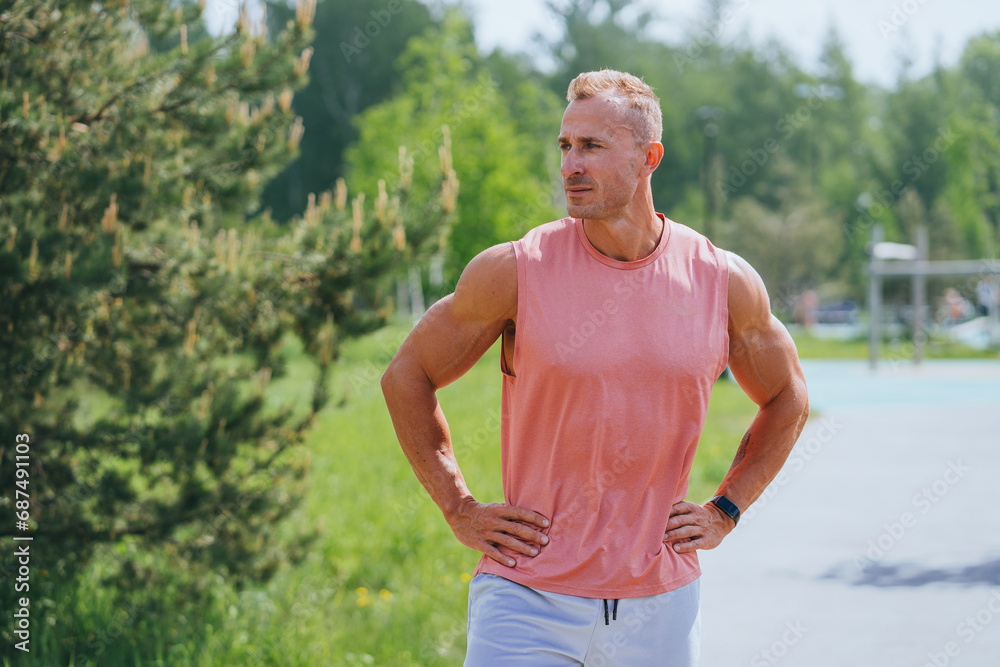 Strong caucasian man in sportswear standing looks aside, tired after ...