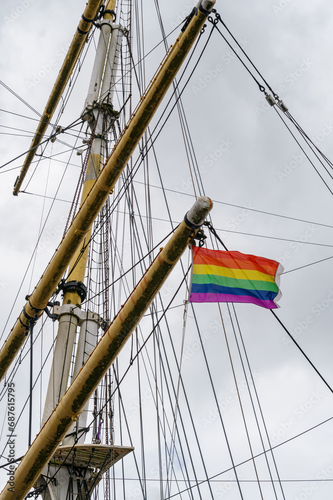 Historic ship mast and rigging with a rainbow pride flag flying Stock ...