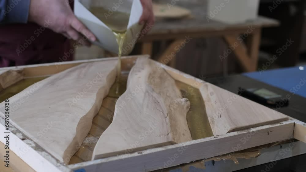 Epoxy resin flows into a live-edge wood form. Captures the beauty of ...