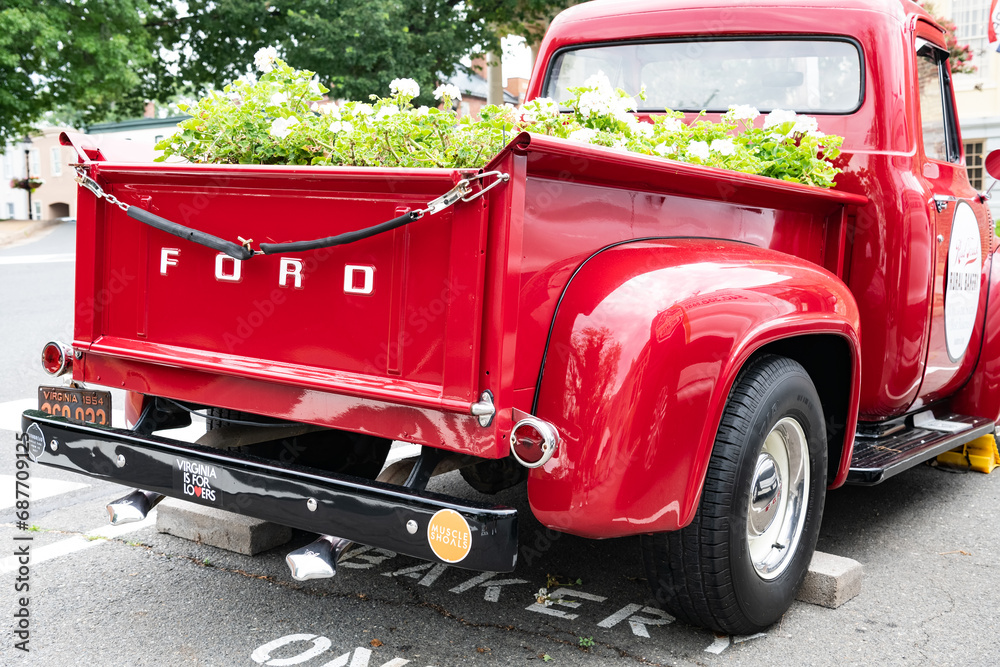 Restored red pickup truck from the 50s, Ford F100 in the parking lot ...