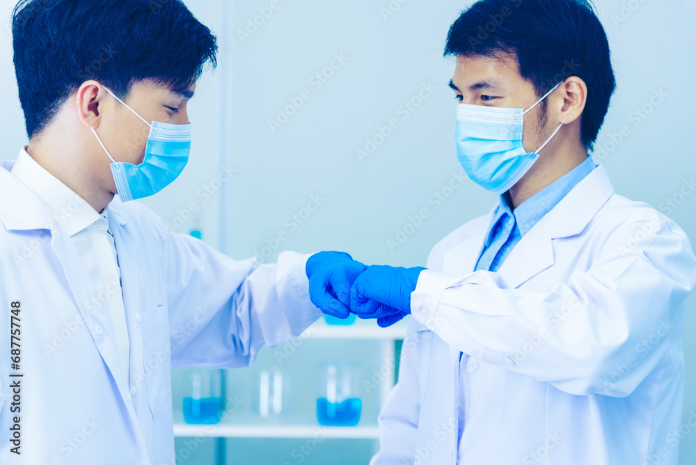 Two asian scientist men fist bump team partner shake hands together ...