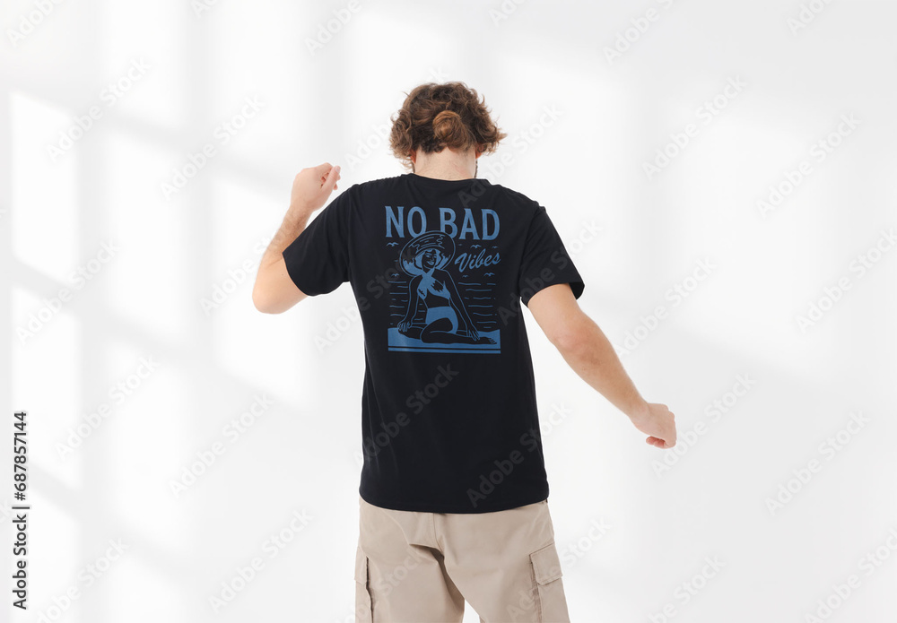 Mockup of man wearing customizable t-shirt with arms out, rear view ...