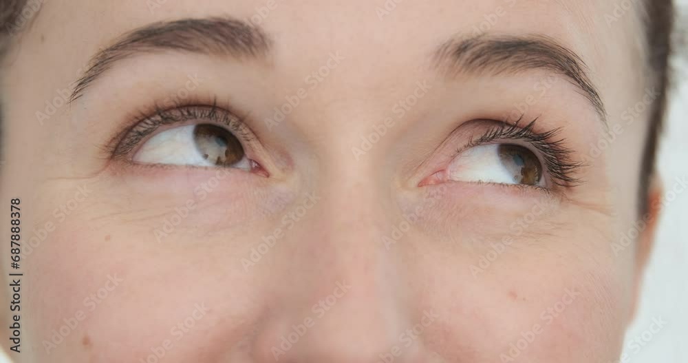 Sly, funny look of woman eyes, close up. Cheerful woman face planning ...