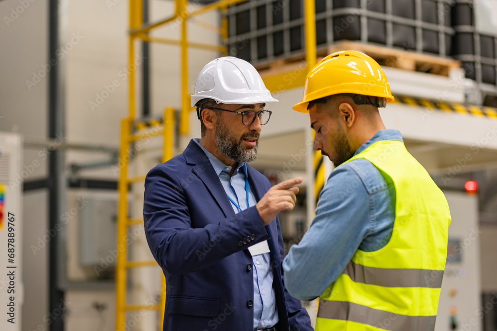 Supervisor, manager scolding employee in modern industry factory ...