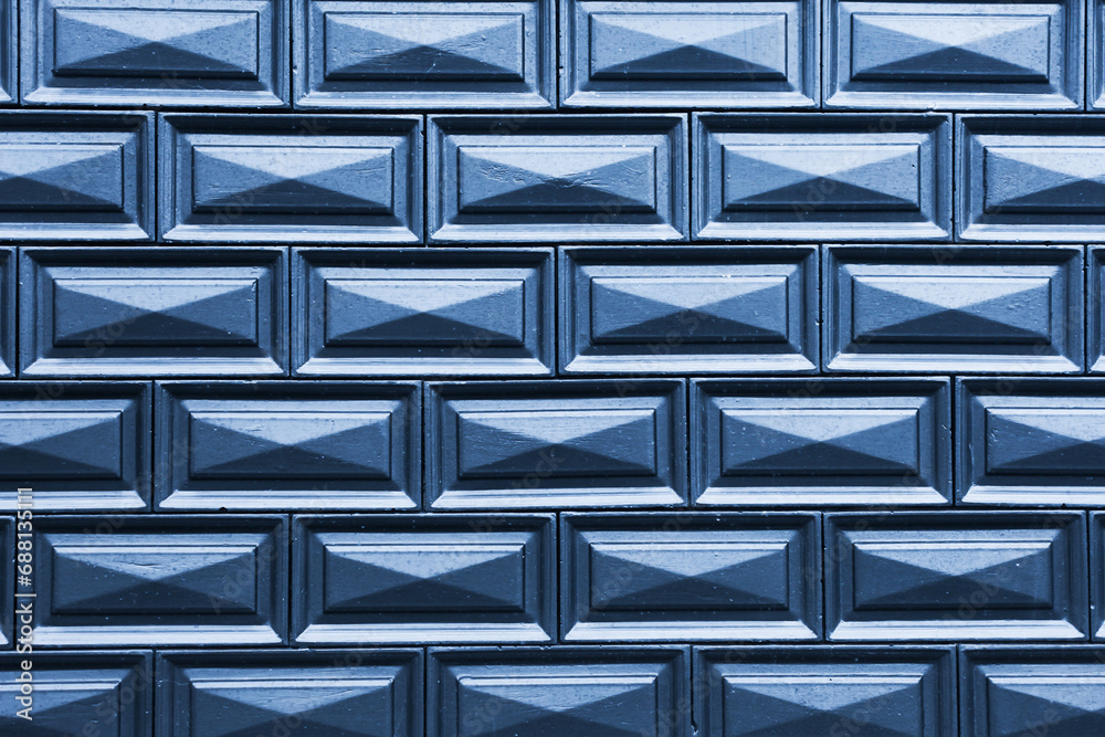 Dark blue tile wall. Rectangle shape tile with triangle design ...