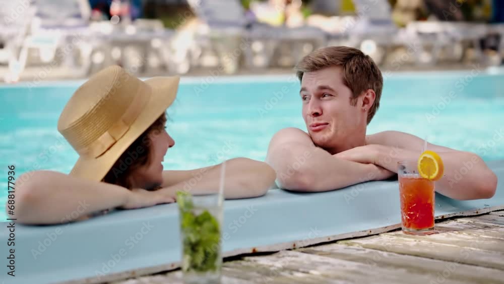 Couple of young lovers having a conversation in swimming pool. Two best ...