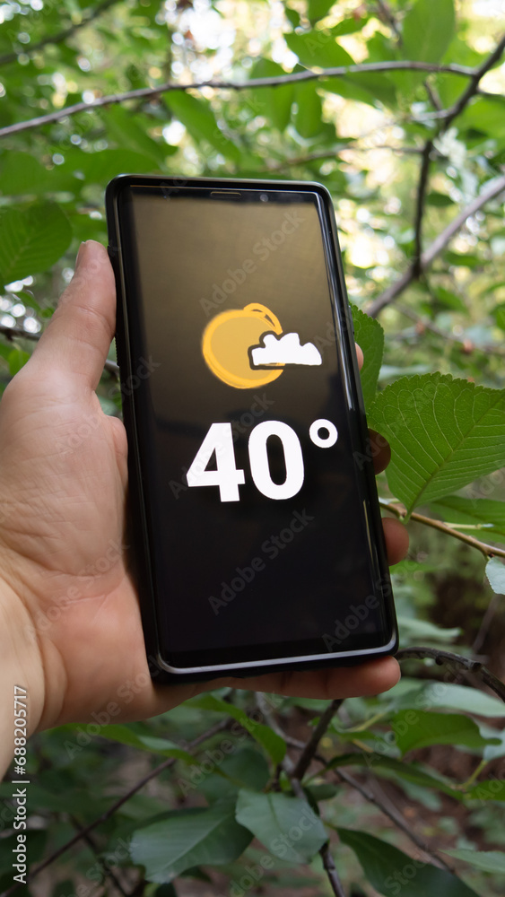 Smartphone thermometer displaying 40 degrees Celsius, indicating warm ...