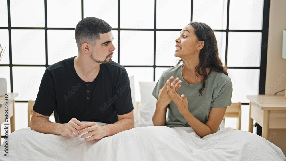 Beautiful couple arguing in bedroom, a serious disagreement amidst a ...