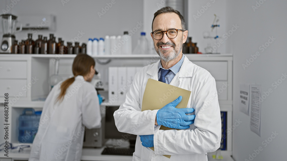Two smiling scientists, partners in crime, nonchalantly standing with ...