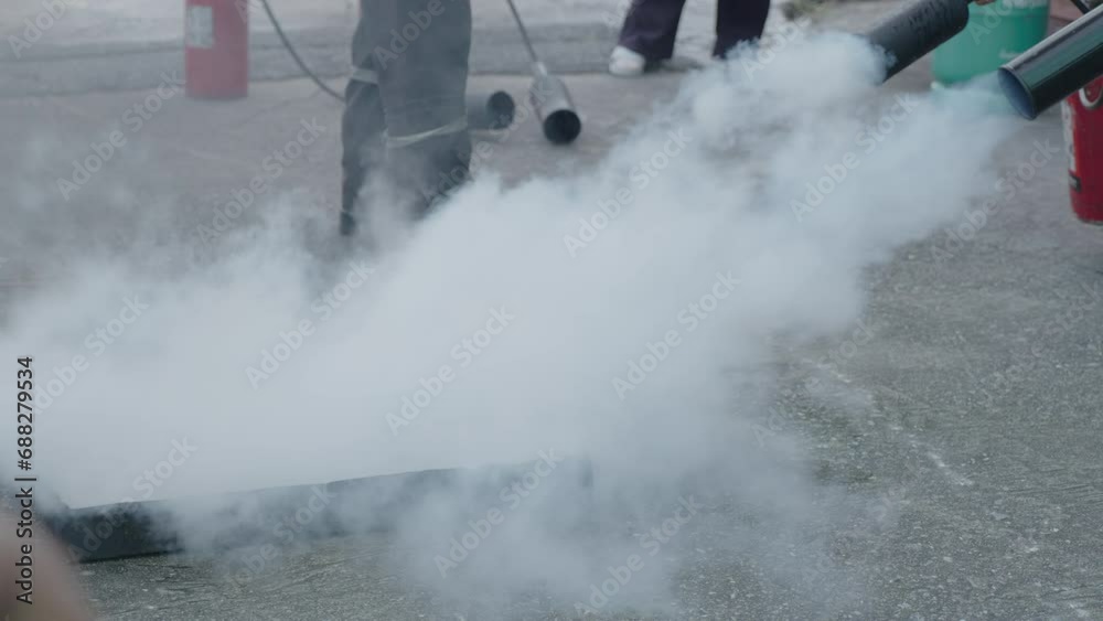 Firefighting drills from fuel combustion by experts. Man teaches or ...