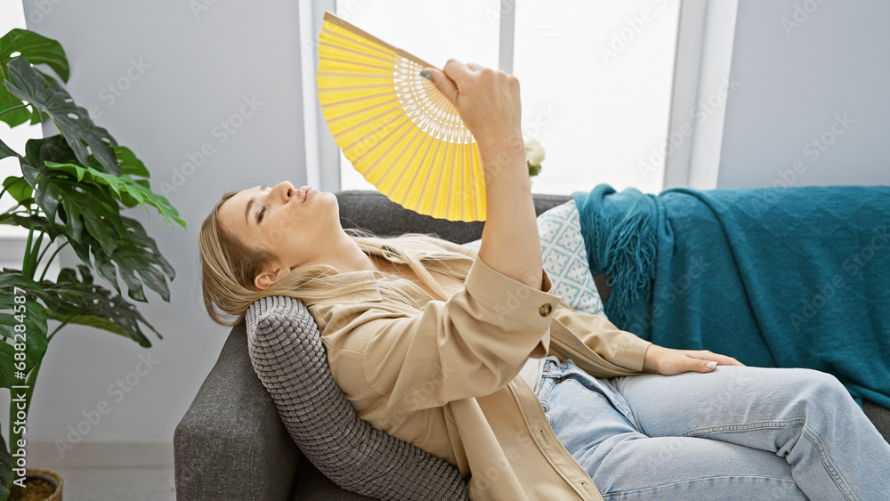 Stunning young blonde woman suffering in hot weather indoors ...
