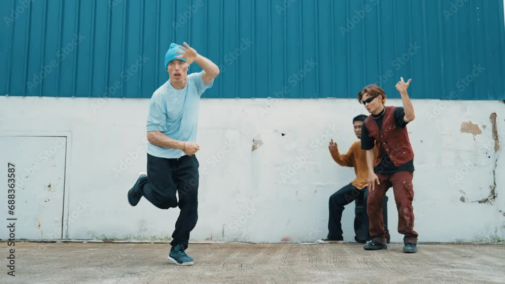 Young street dancer dancing in hip hop style with multicultural friends ...