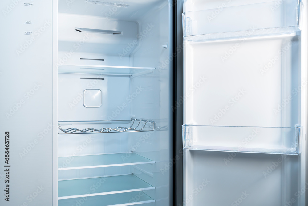 Empty refrigerator with open door Inside an empty, clean refrigerator ...