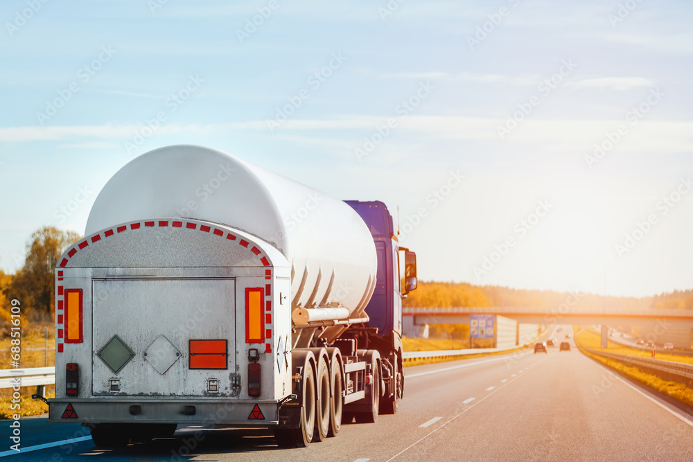 Semi truck with propane tank moving on asphalt road. ADR dangerous ...