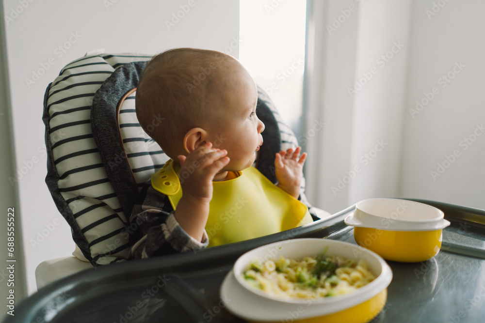 Little child with solid nutrition. Baby girl eating finger food and mix ...