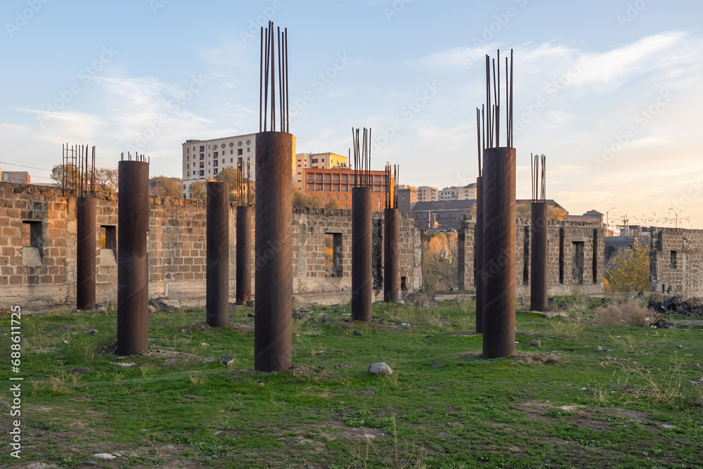Abandoned construction site. Columns with protruding reinforcement ...