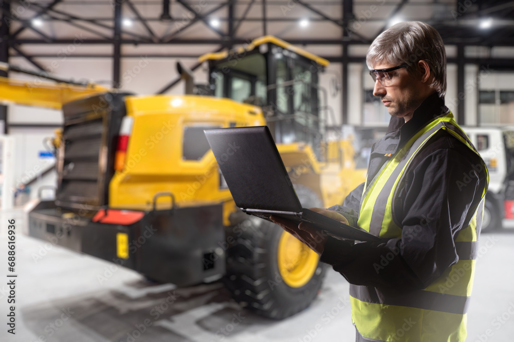 Construction company employee. Man builder with laptop. Construction ...