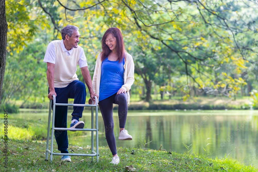 Asian senior man with walker and his daughter walking together in the ...