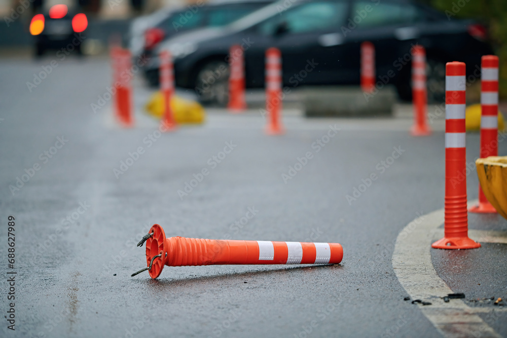 Broken plastic orange barrier, damaged parking bollard. Car knocked ...