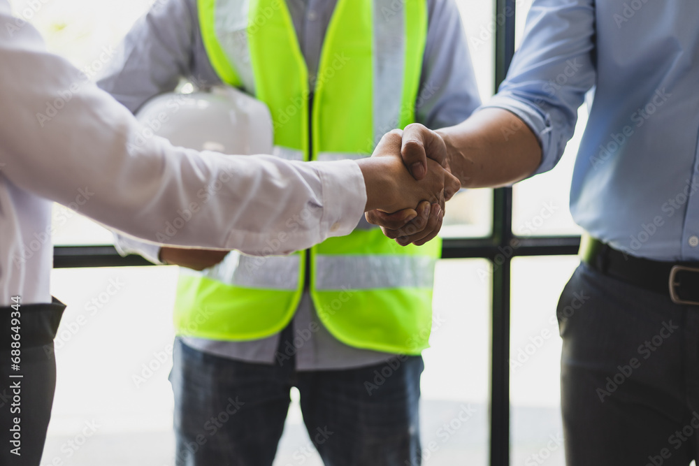 Collaboration of engineers, architects and contractors. Architects hand ...