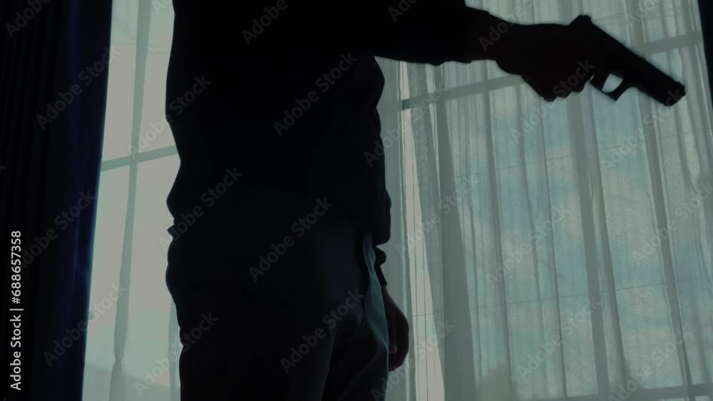 Mysterious man wearing black hoodie holding a pistol wearing a cloth ...