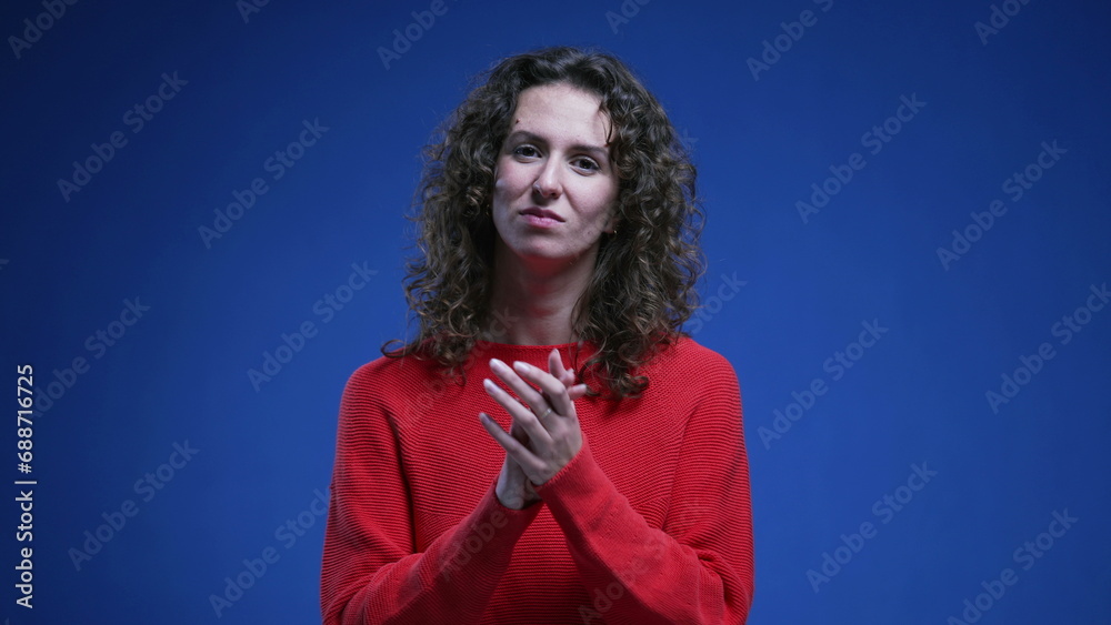 Young woman applauding viewer and pointing finger acknowledging ...