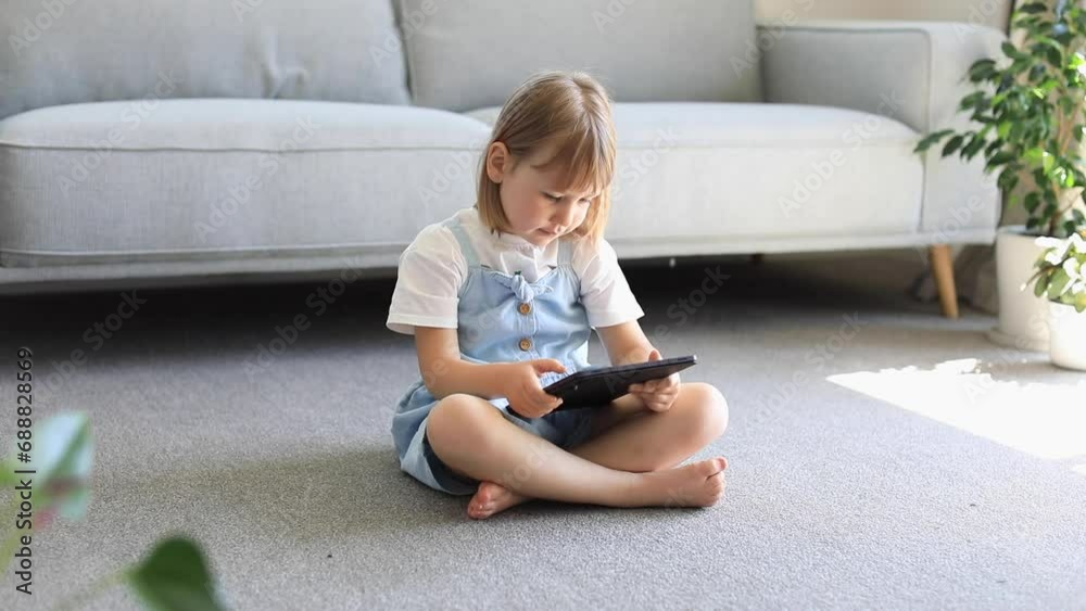 A preschool girl uses a digital device. Children's educational apps for ...