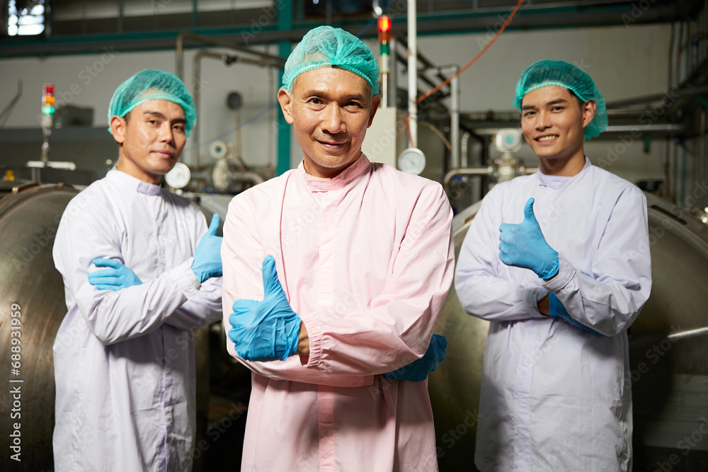 portrait factory workers team smiling and thumbs up pose in the ...