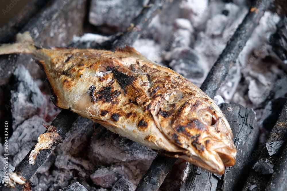 grouper grilled on a charcoal grill. grilled sea fish. Indonesian food ...