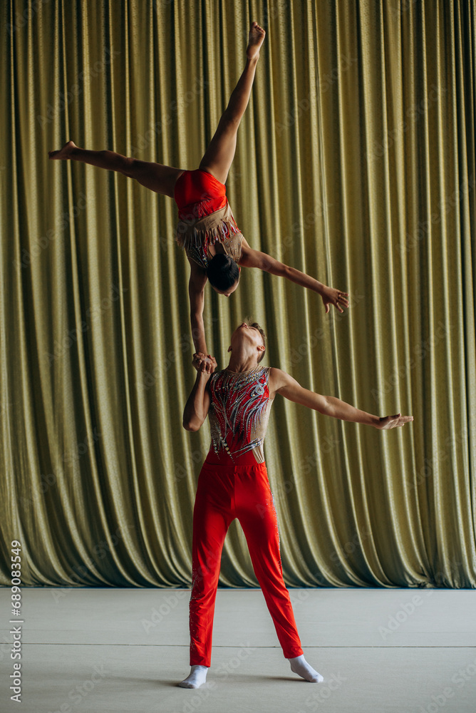 A girl and a young boy compete in sports acrobatics. Championship in ...