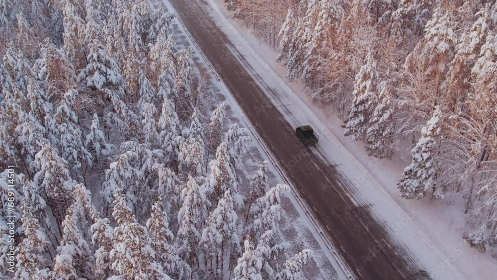 Pickup truck driving on a winter road, aerial photography of a pickup ...