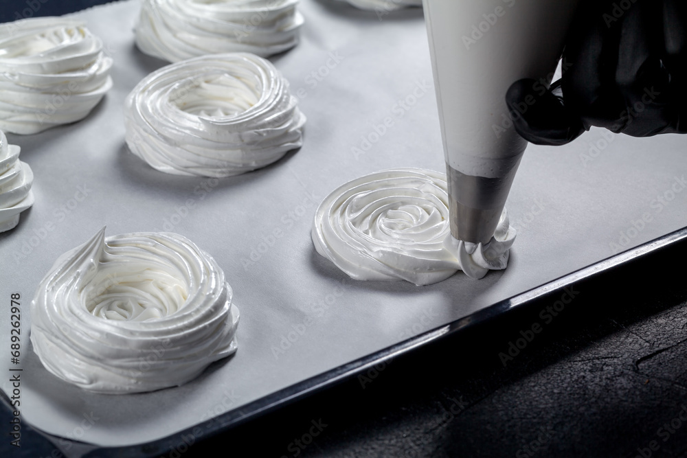 The process of making Pavlova dessert. The confectioner shapes the ...