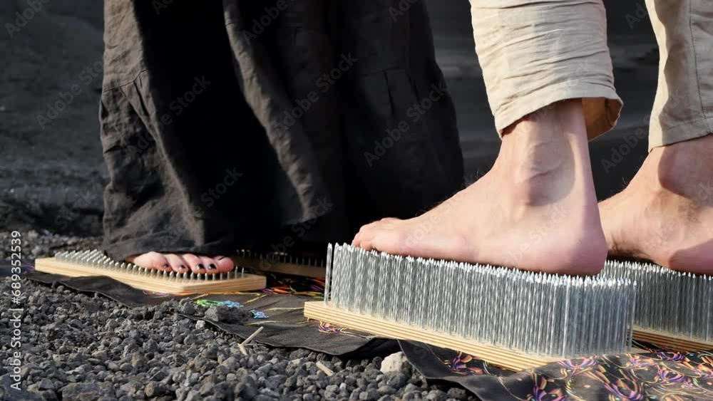 Vidéo Stock Male and female bare feet step on sharp metal nails on a ...