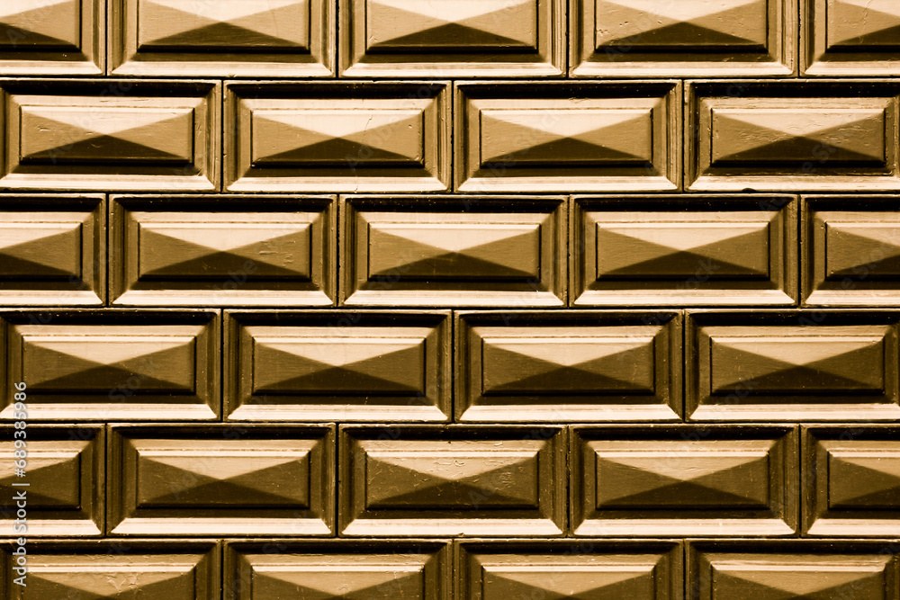Golden tile wall. Rectangle shape tile with triangle design. Decorative ...