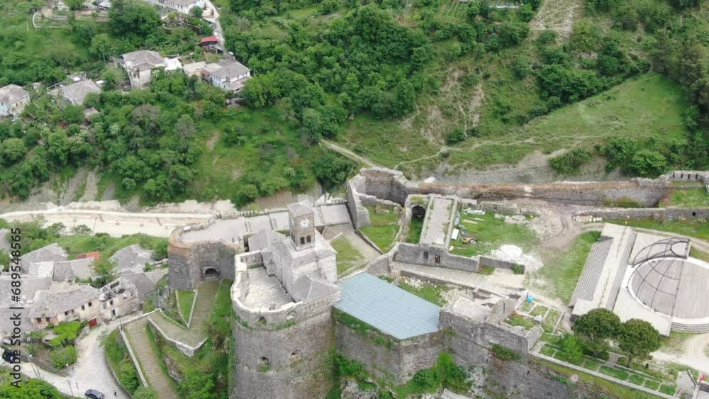 Drone view in Albania flying in Gjirokaster town over a medieval castle ...