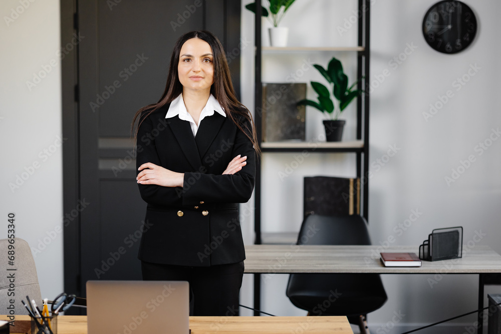Portrait of a business woman in an office. A pretty young woman is ...