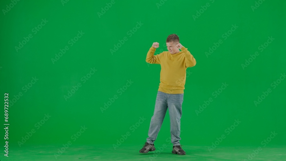 Portrait of kid boy on chroma key green screen. Schoolboy in jeans ...