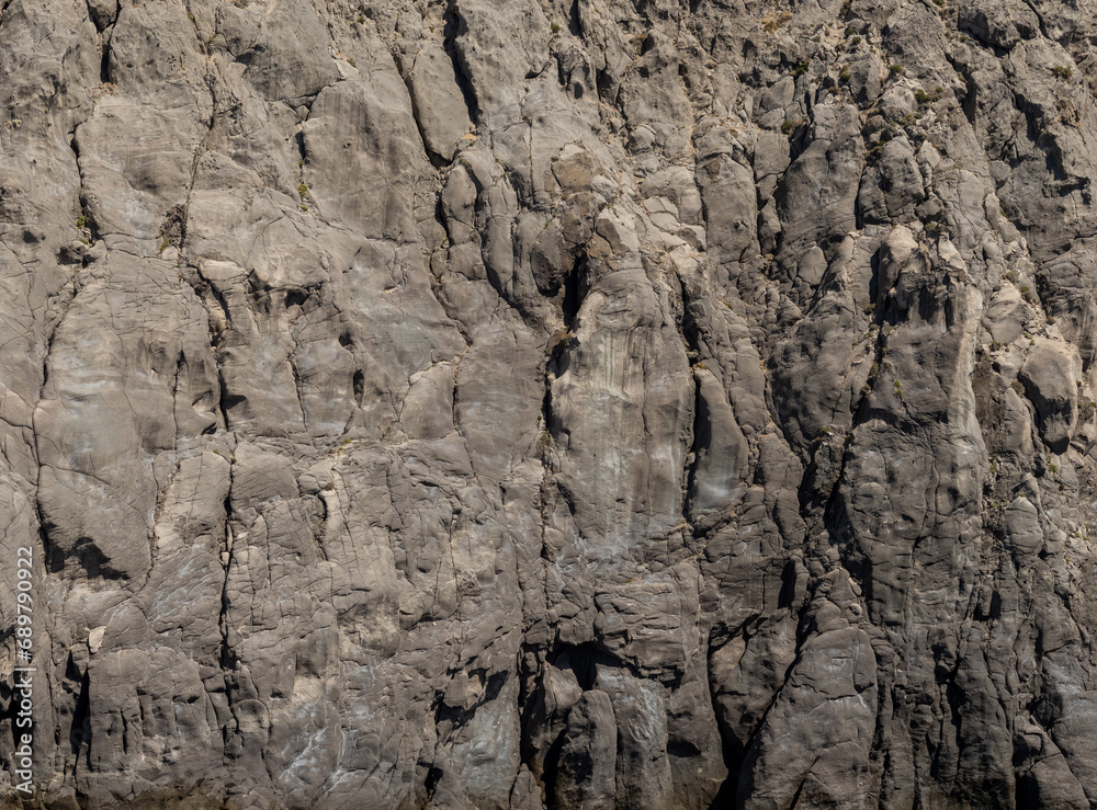 Weathered seaside rock face texture. Aged volcanic stone wall surface ...