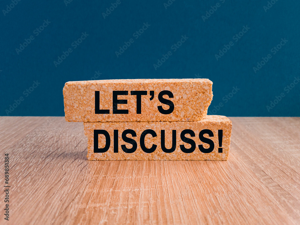 Let's discuss symbol. Concept word LET'S DISCUSS on brick blocks ...