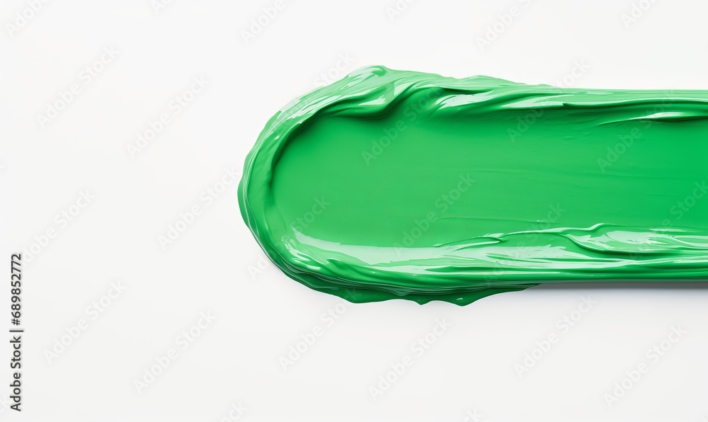 A smooth, bright green smear of paint spread across a white background ...