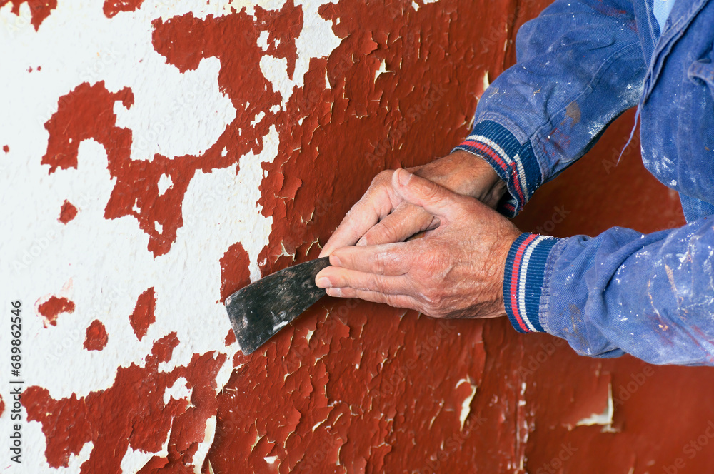 bricklayer mason painter worker removing peeling paint on wall with a ...