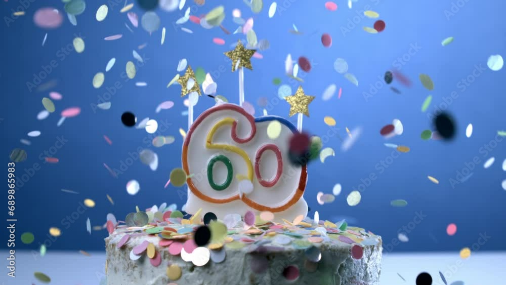 Anniversary celebration with the number 60 on top of cake and confetti ...