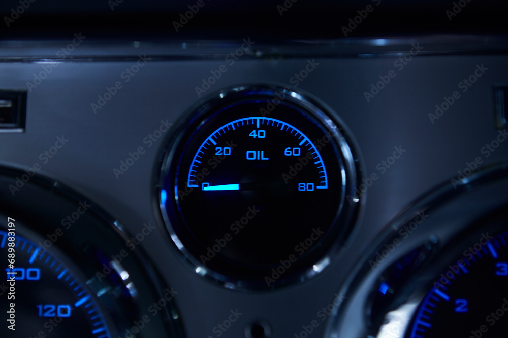 Dashboard of an illuminated sports car. Gas, oil, speed indicator ...