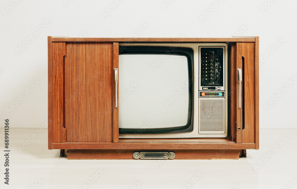 Antique old TV receiver, old fashioned wooden case in a white room ...